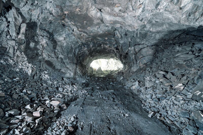 Underground Mining, Tunnel in the Rock. There is a Bright Light at the ...
