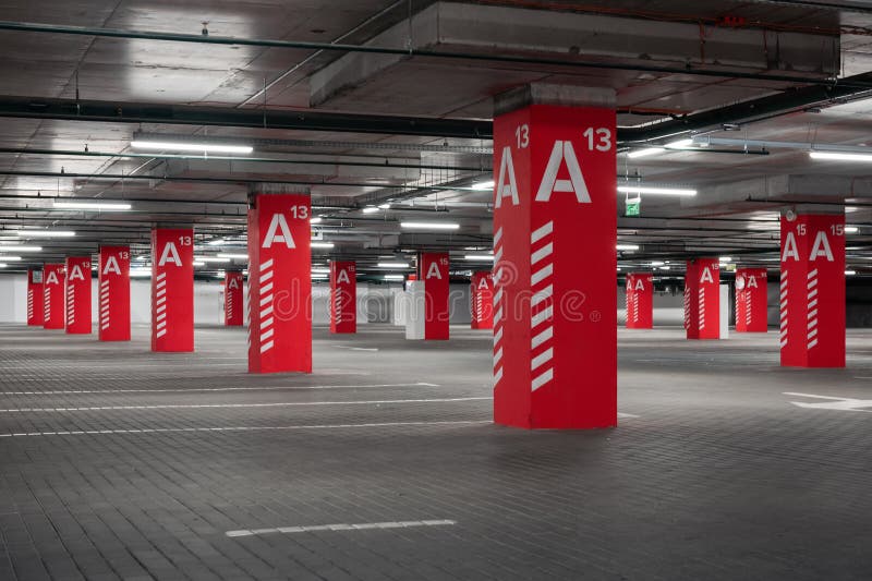 Underground Parking Garage with Red Pillars. Stock Photo - Image of ...
