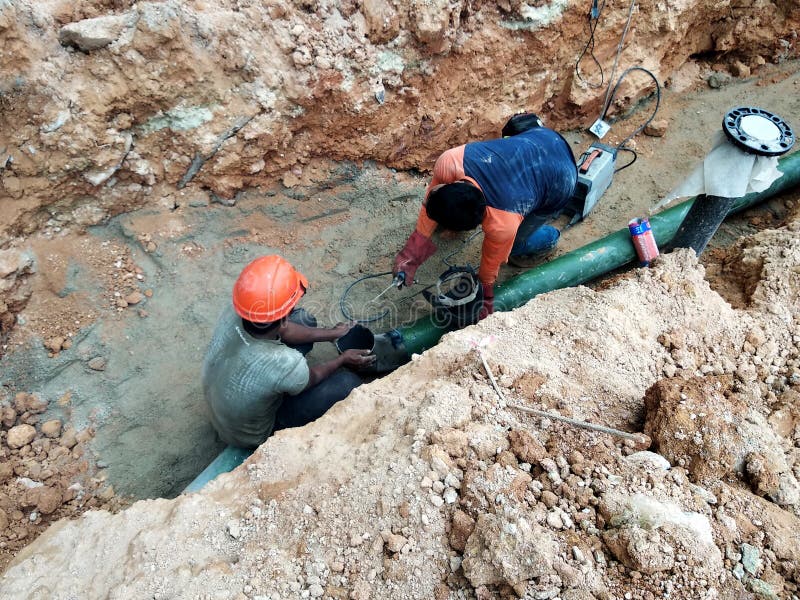 Underground Utility and Services Pipe Laid by Workers in the Trenches ...