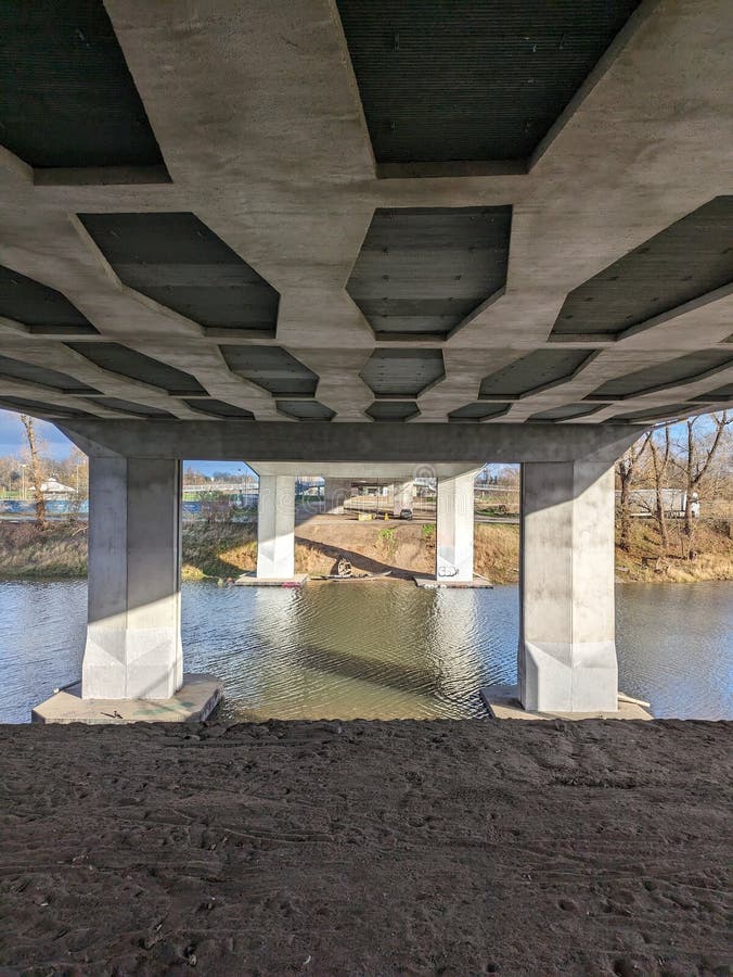 Underneath the Bridge, a Hidden World Unfolds, Where the River ...