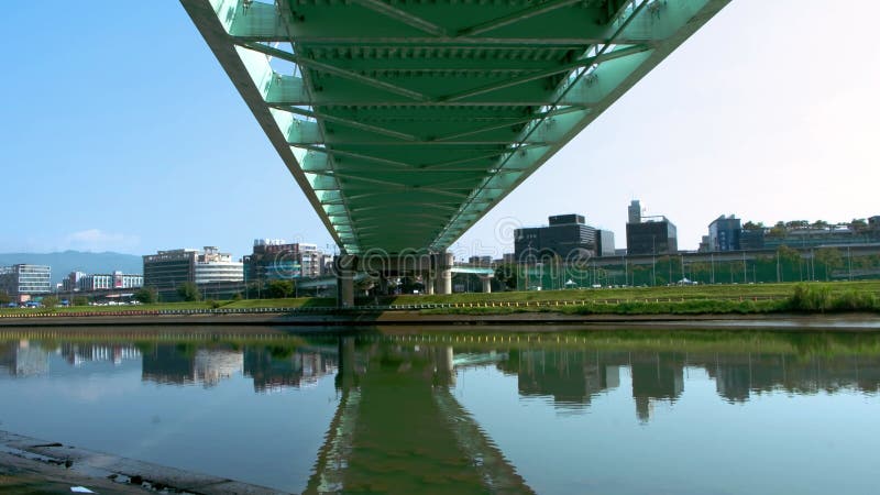The Underside of a Green Bridge Across an Asian River Stock Video ...