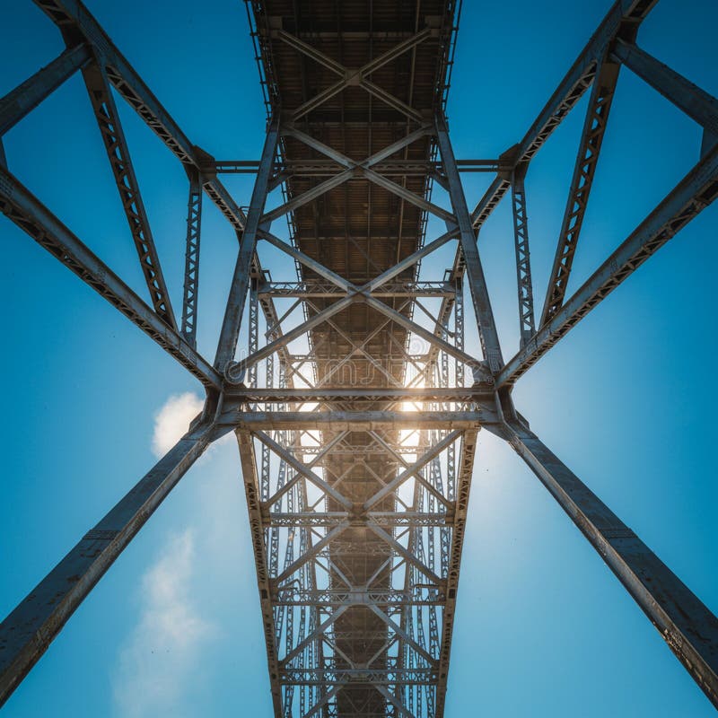 Underneath View of a Large Steel Truss Bridge Structure Against a Clear ...