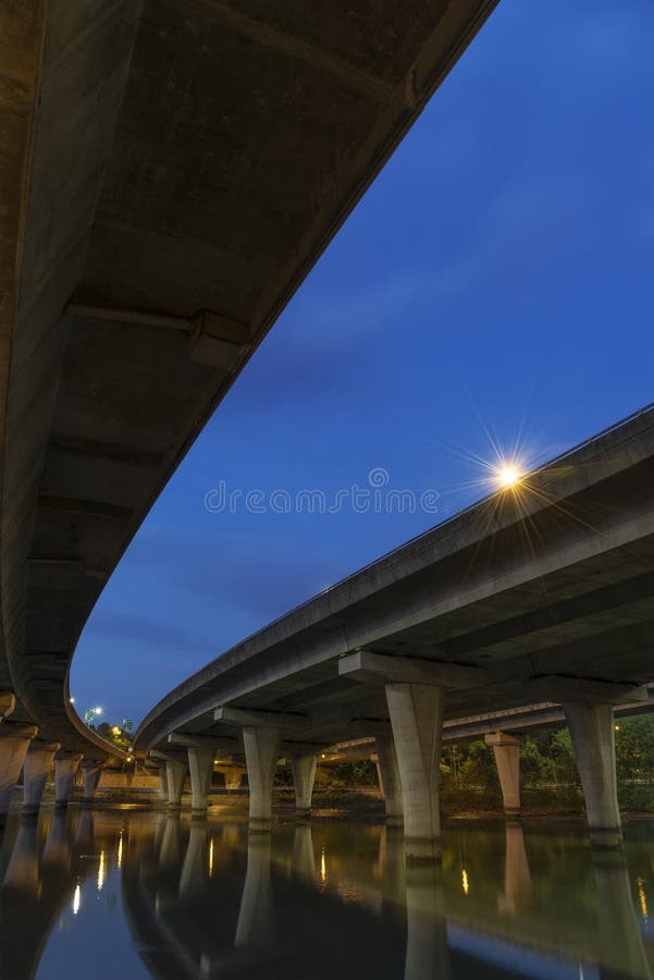 Underside of an Elevated Road Across River at Dusk Stock Image - Image ...