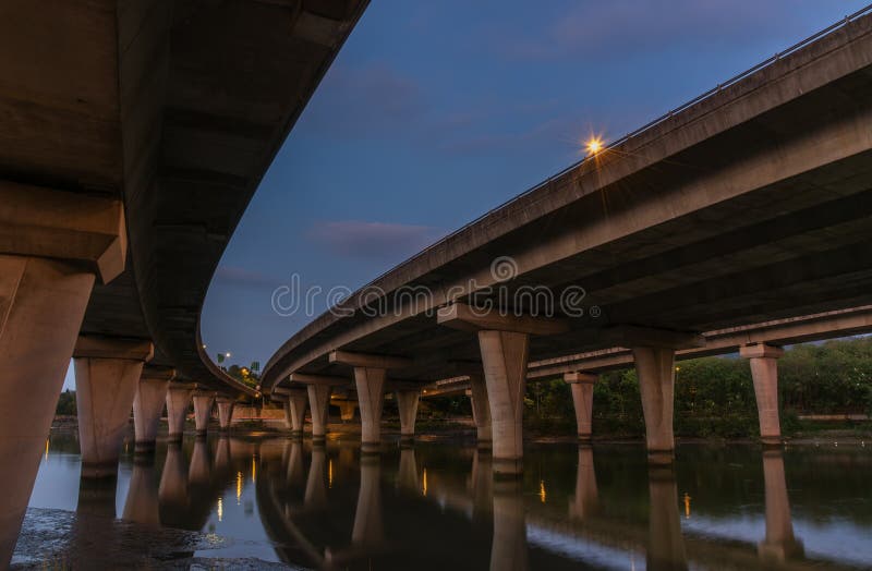 Underside of an Elevated Road Across River at Dusk Stock Image - Image ...