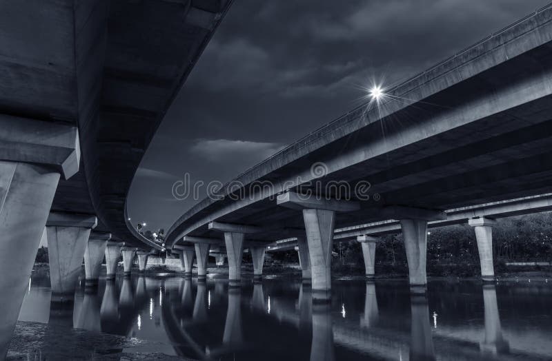 Underside of an Elevated Road Across River at Dusk Stock Image - Image ...