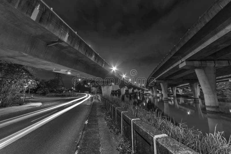 Underside of an Elevated Road Across River at Night Stock Photo - Image ...
