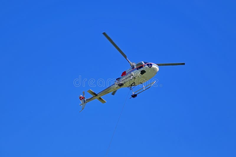 Underside of Utility Helicopter with Lifting Cable Stock Image - Image ...