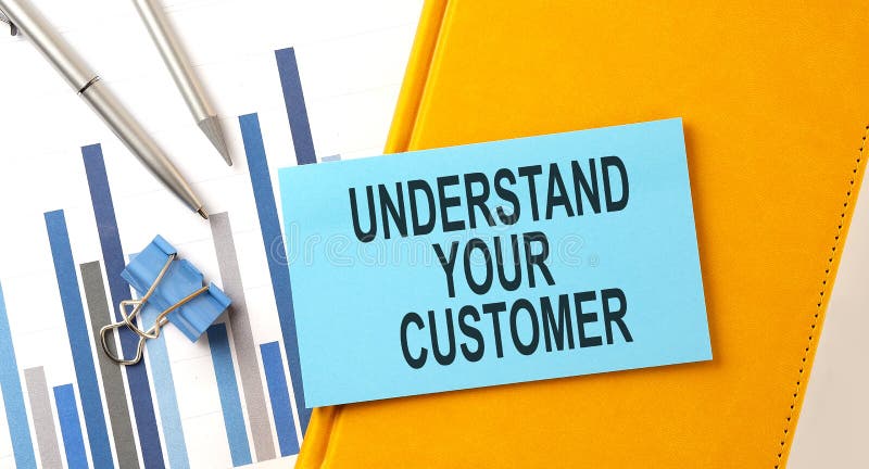 UNDERSTAND YOUR CUSTOMER Text on Sticker on the Yellow Notebook with ...