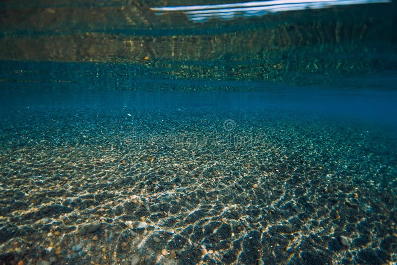 Underwater Crystal Ocean with Stone Bottom and Reflection on Surface ...