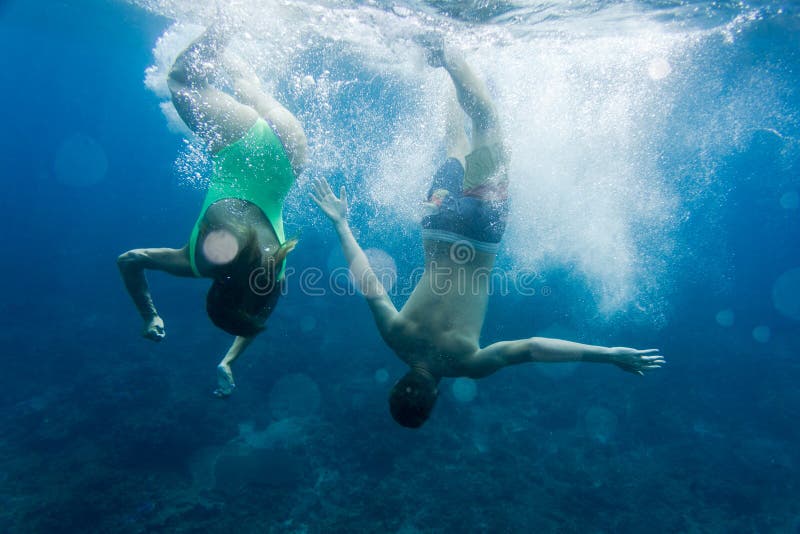 Couple diving underwater stock image. Image of diving - 33779703