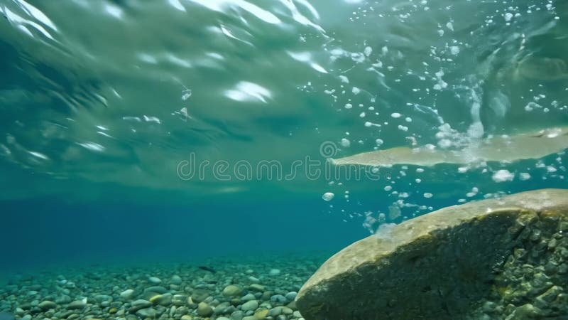 Underwater Scene of a Large Rock with Bubbles Rising from the Bottom ...
