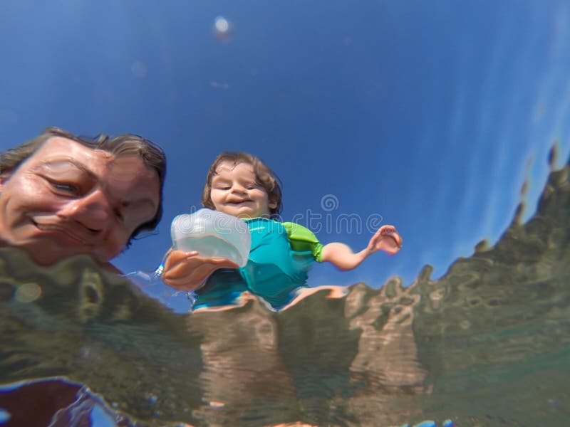 Underwater View of a Father and Her Daughter with Distorted Faces ...