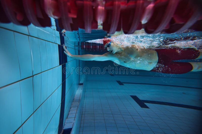 Underwater View of Swimmer in Red Cap Reaching Edge of Pool. Young Man ...