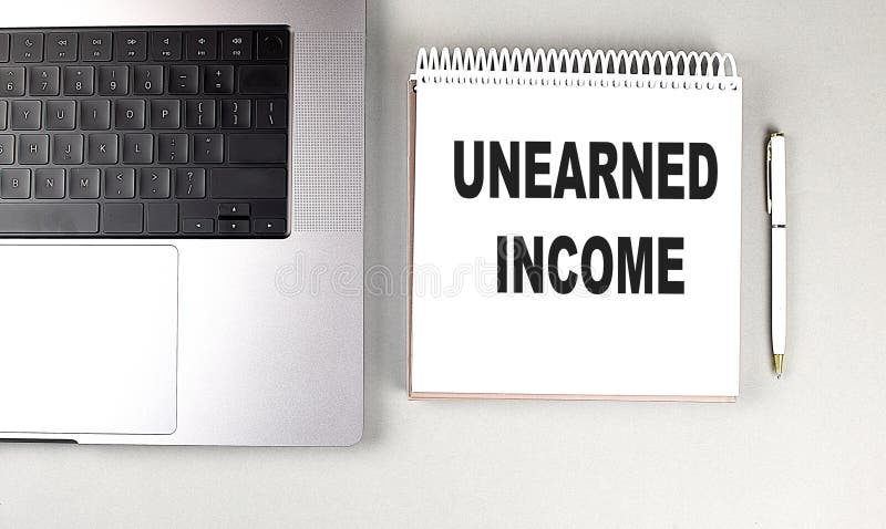 UNEARNED INCOME Text on Notebook with Laptop, Mouse and Pen Stock Photo ...