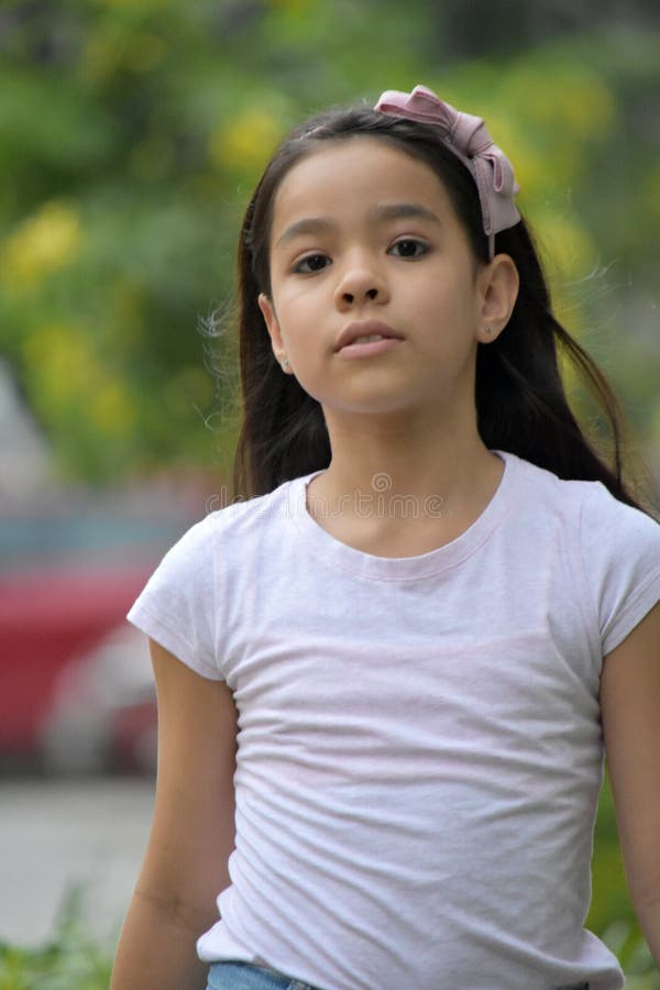 An Unemotional Petite Girl stock image. Image of serious - 156769899