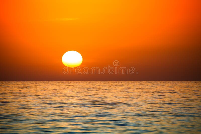 Uneven Disk of the Sun Setting Over the Horizon Stock Image - Image of ...