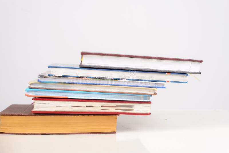 Uneven Stack of Colorful Books Lying on Table, Side View Stock Photo ...