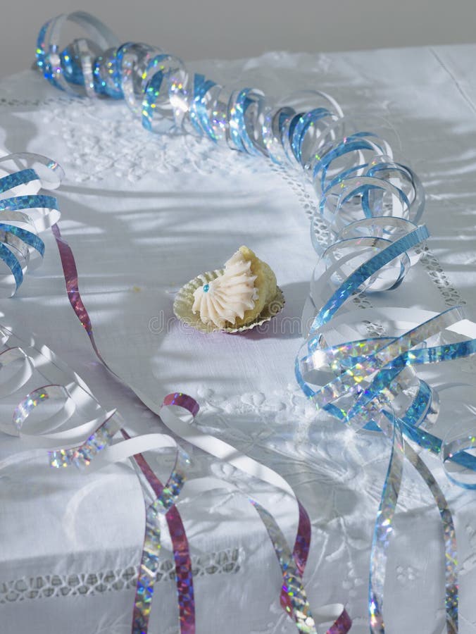 Unfinished Cup Cake Amongst Streamers on Table Elevated View Stock ...