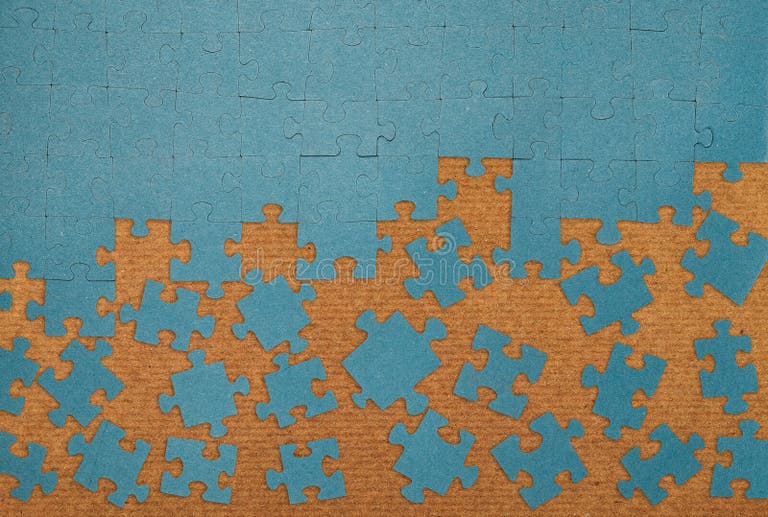 Unfinished Jigsaw Puzzle with Scattered Blue Pieces on a Textured ...