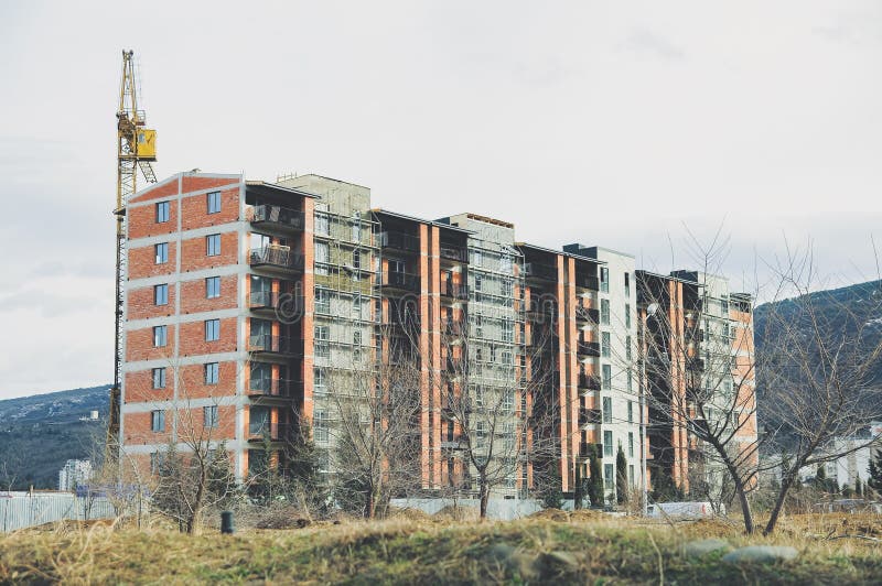 Unfinished Building and a Lifting Crane Stock Photo - Image of lifting ...