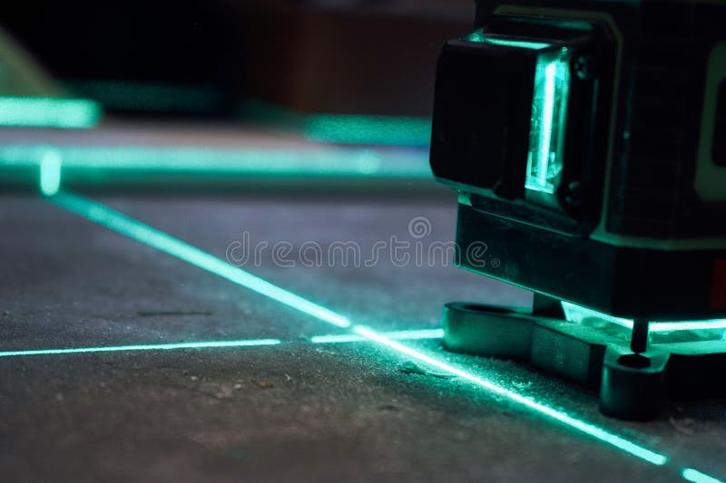 In an Unfinished Room, Two Green Laser Lines Overlap on the Floor ...