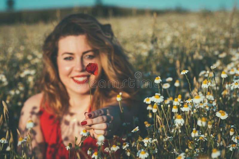 Unfocused Woman Showing a Poppy Stock Image - Image of cheerful ...