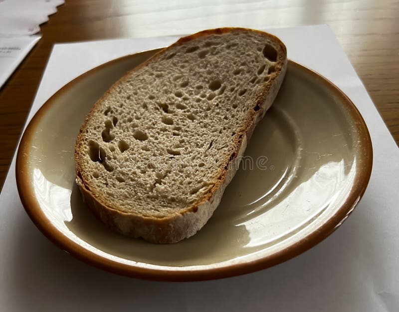 An Ungreased Slice of Bread Lying on a Faience Plate Stock Photo ...