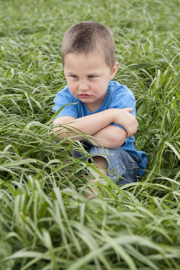 Unhappy boy in meadow stock image. Image of blue, oudoors - 24441753
