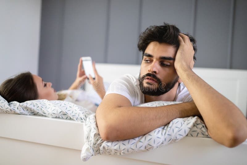 Unhappy Couple Ignoring Each Other Using Mobile Phone. Stock Photo ...