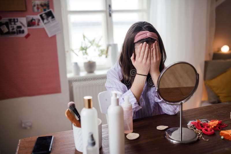 Unhappy Girl Doing Her Skin Routine in Her Room. Stock Image - Image of ...