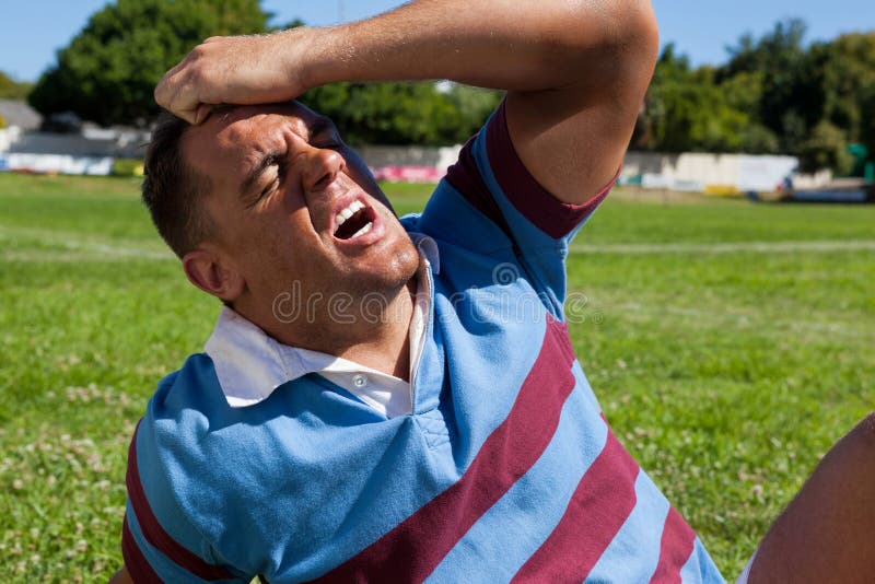 Unhappy Rugby Player Sitting on Field Stock Photo - Image of front ...