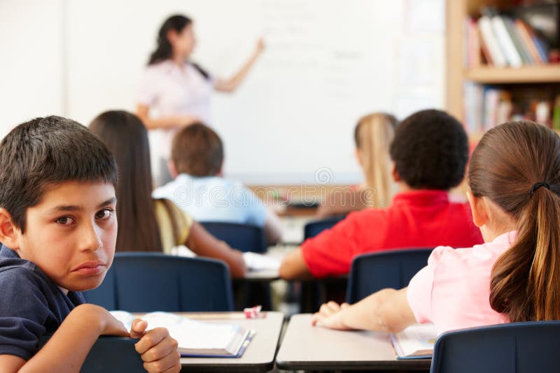 Unhappy schoolboy in class stock image. Image of caucasian - 25389385