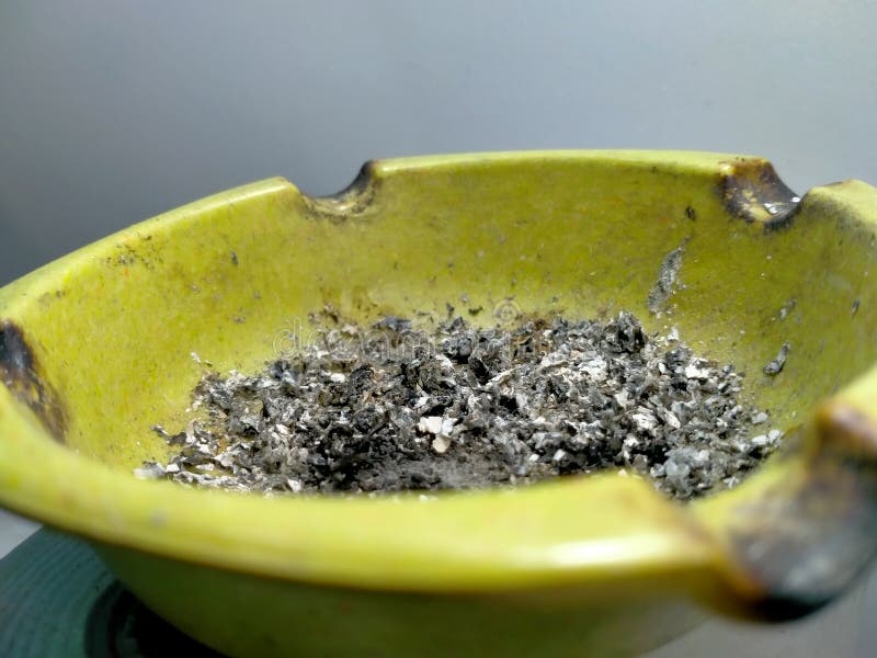 The Unhealthy Cigarette Ash is Displaying in the Ashtray Background ...