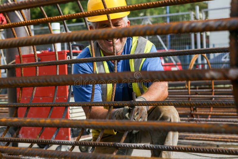 Unidentified Workers Working with Concrete Iron at a Construction Site ...