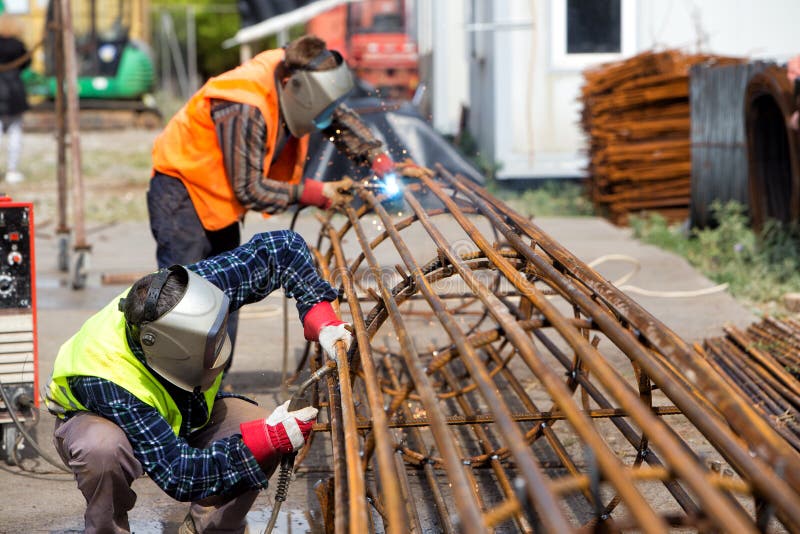 Unidentified Workers Working with Concrete Iron at a Construction Site ...