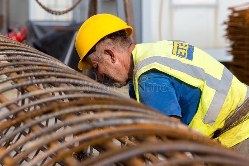 Unidentified Workers Working with Concrete Iron at a Construction Site ...