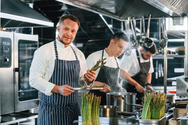 In Uniform. Kitchen Workers is Together Preparing the Food Stock Photo ...