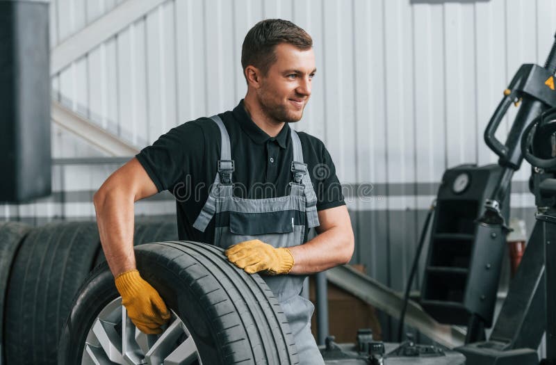 In Uniform. Man is Working in the Auto Service Stock Image - Image of ...