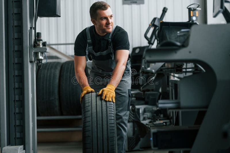 In Uniform. Man is Working in the Auto Service Stock Image - Image of ...