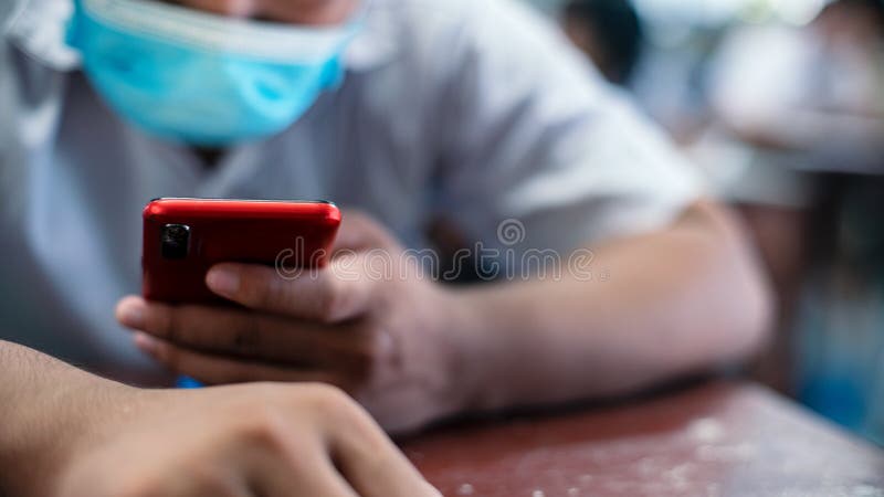 Uniform Students are Study Online or Test Exam by Using Smartphone and ...