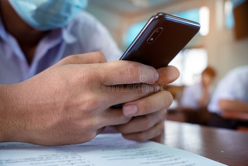 Uniform Students are Test Exam and Study Online by Using Smartphone and ...