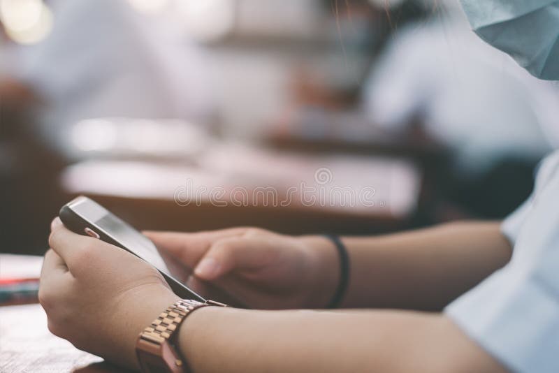 Uniform Students are Test Exam and Study Online by Using Smartphone and ...