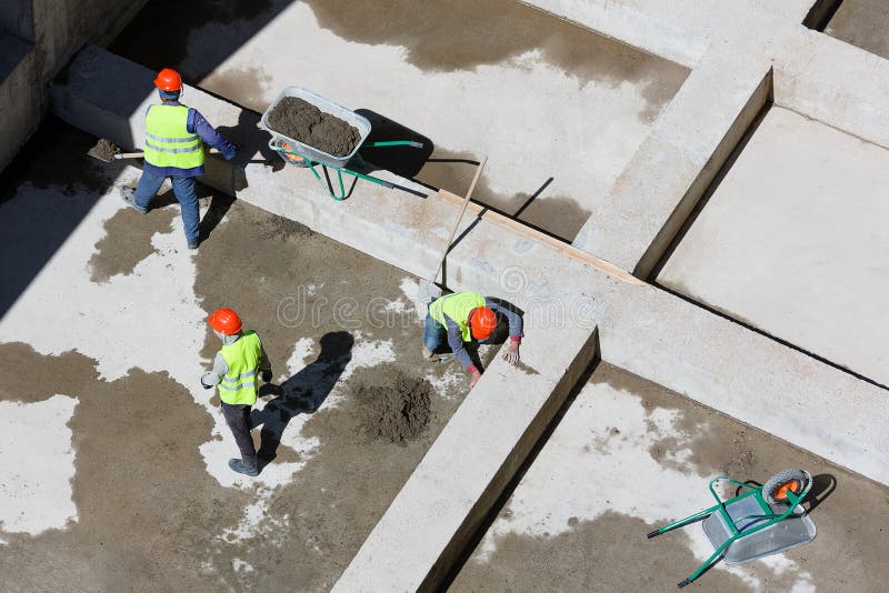 Uniformed Workers Clean Sand on a Construction Site, Top View Editorial ...