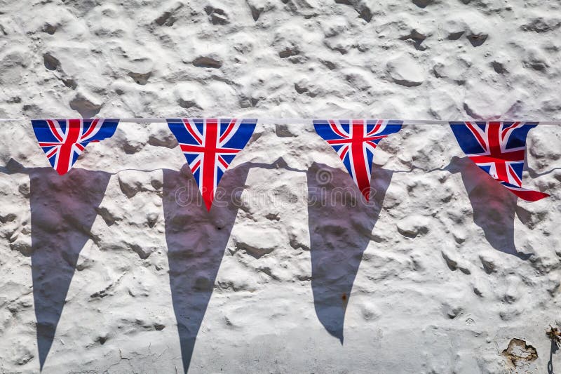 Union Jack Bunting Hanging Against a White Wall in the Sunshine Stock ...