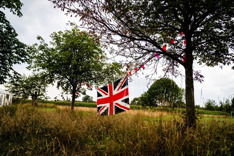 Union Jack Flag Stretched between Trees Stock Image - Image of ...