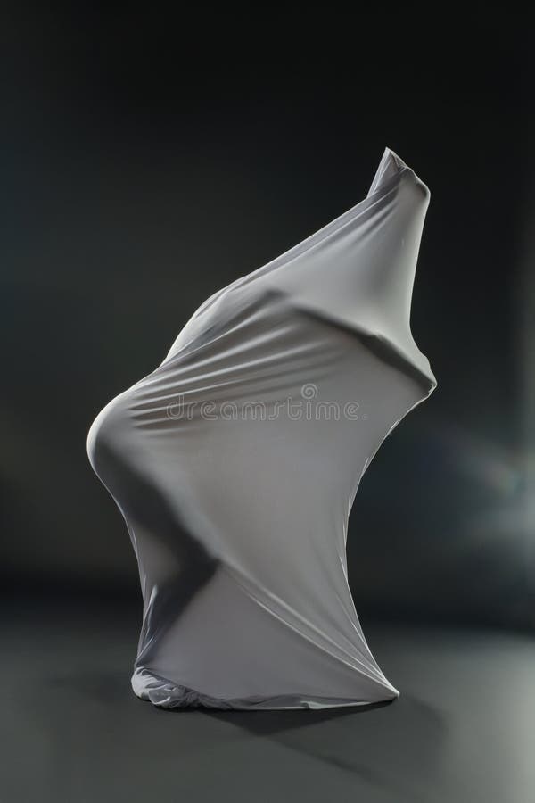 Unique Abstract Figure Draped in Fabric in a Dark Studio Setting Stock ...