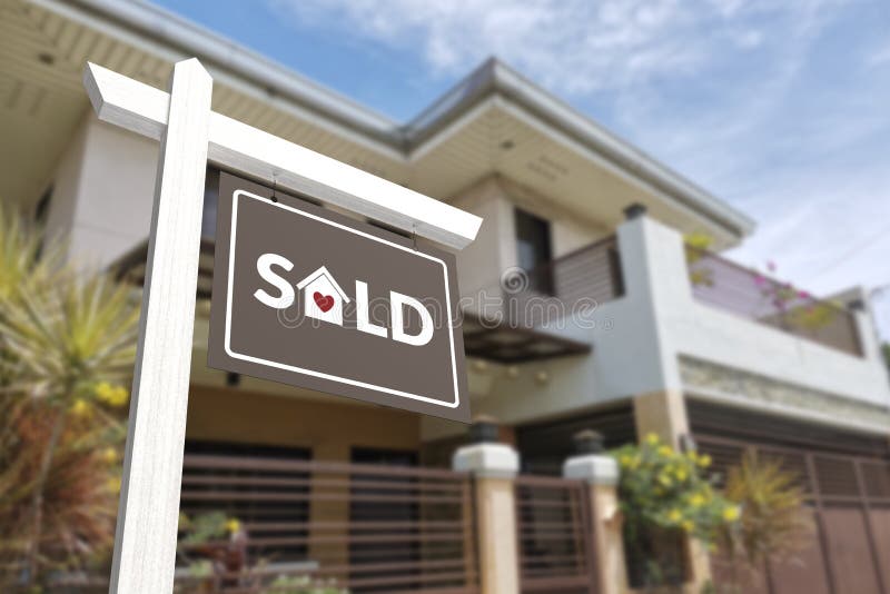 A Unique and Cute Sold Sign in Front of a 2 Gated Story House Stock ...