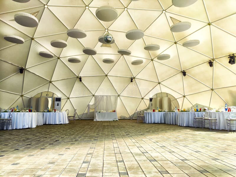 Unique Indoor Event Space Featuring Elegant Tables and a Disco Ball in ...