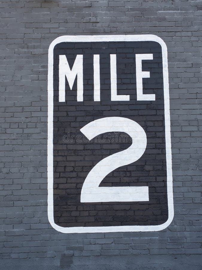 Unique 2 Mile Sign on Grey Painted Brick Wall Stock Image - Image of ...