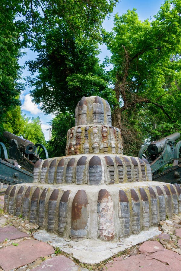 Unique Monument Featuring Artillery and Layered Stone Structure in a ...